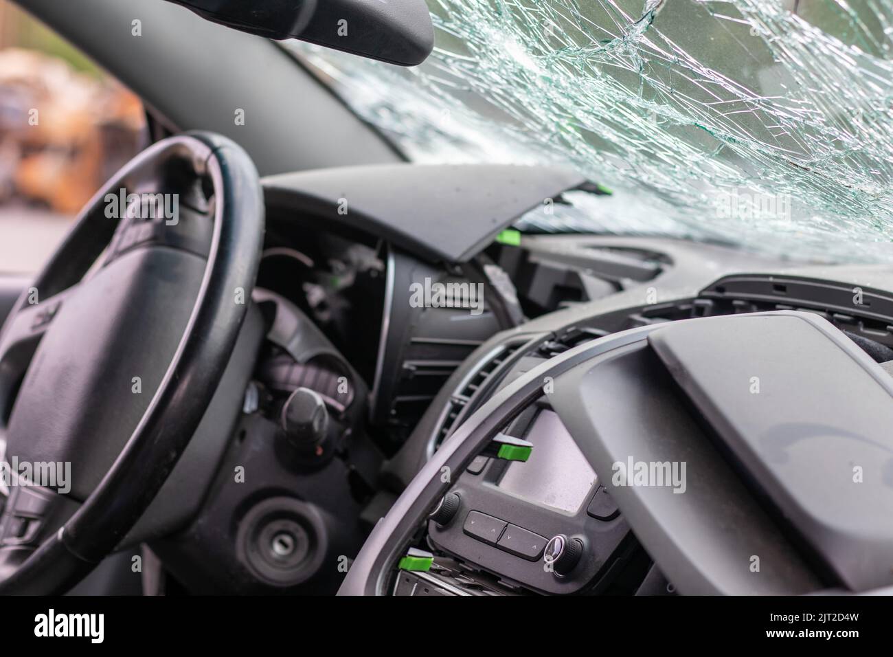 Damaged car window after an accident. Broken windshield as a result of ...