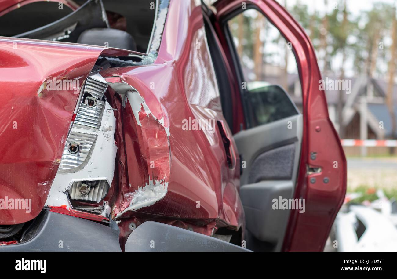 Red car after a terrible accident on the side of the road. Frontal and ...