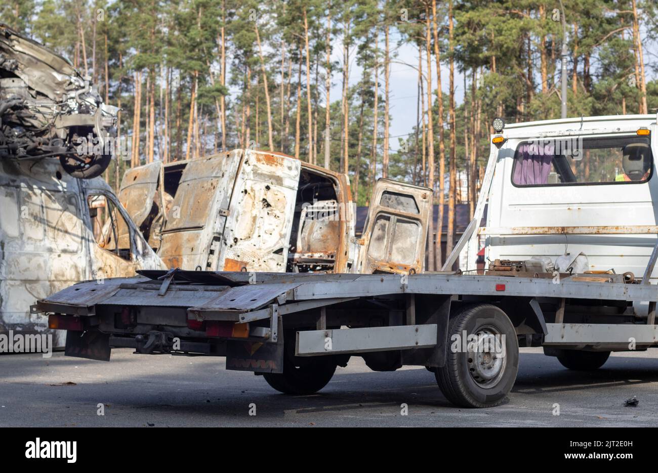 Lots of old cars ready for recycling. Car removal by tow truck. Damaged ...