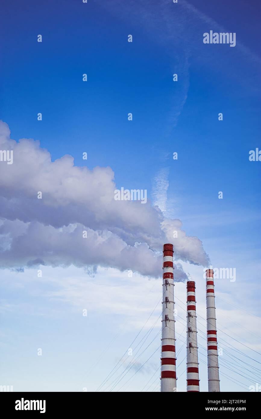 Air pollution. Thick smoke from chimneys in industrial plant ...