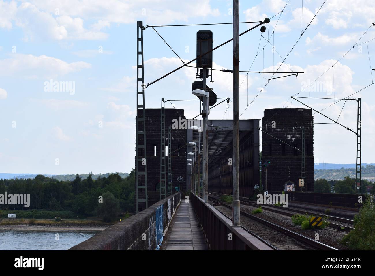 railroad bridge across the Rhine with a way to walk next to the ...