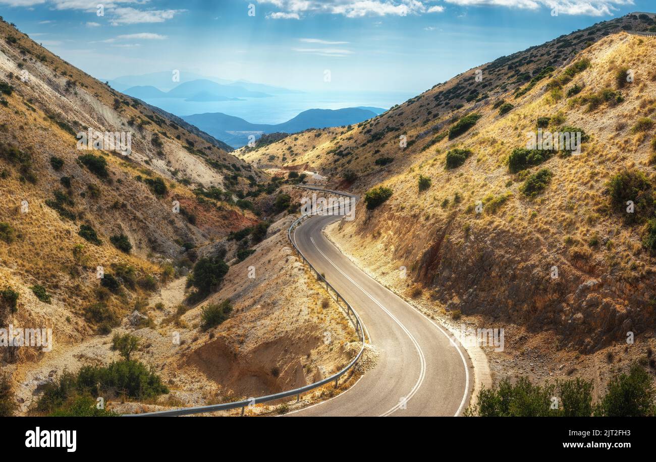 Aerial view of winding mountain road, blue sky with clouds Stock Photo ...