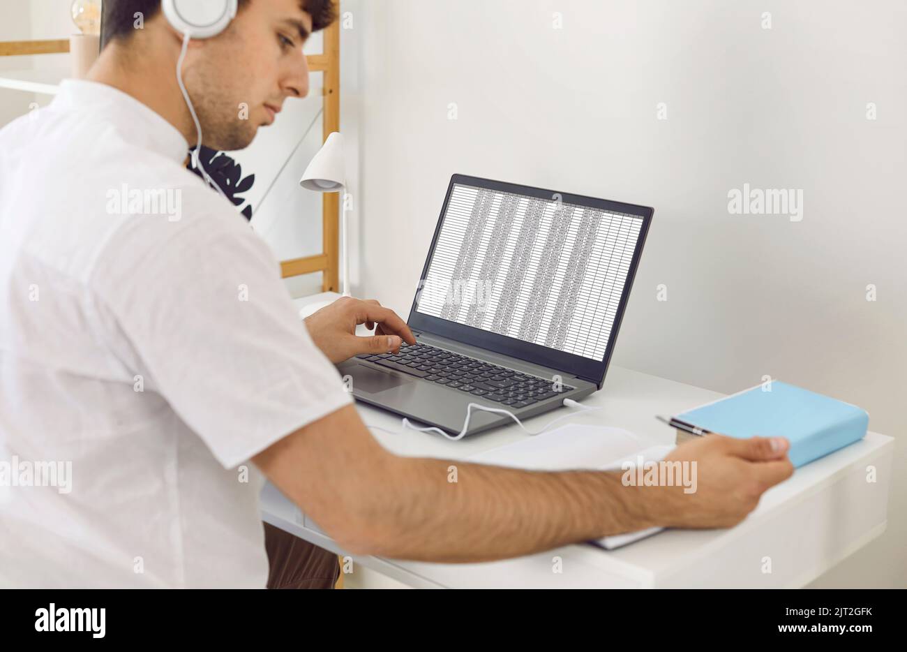Man sitting at desk with laptop, working with business spreadsheets ...