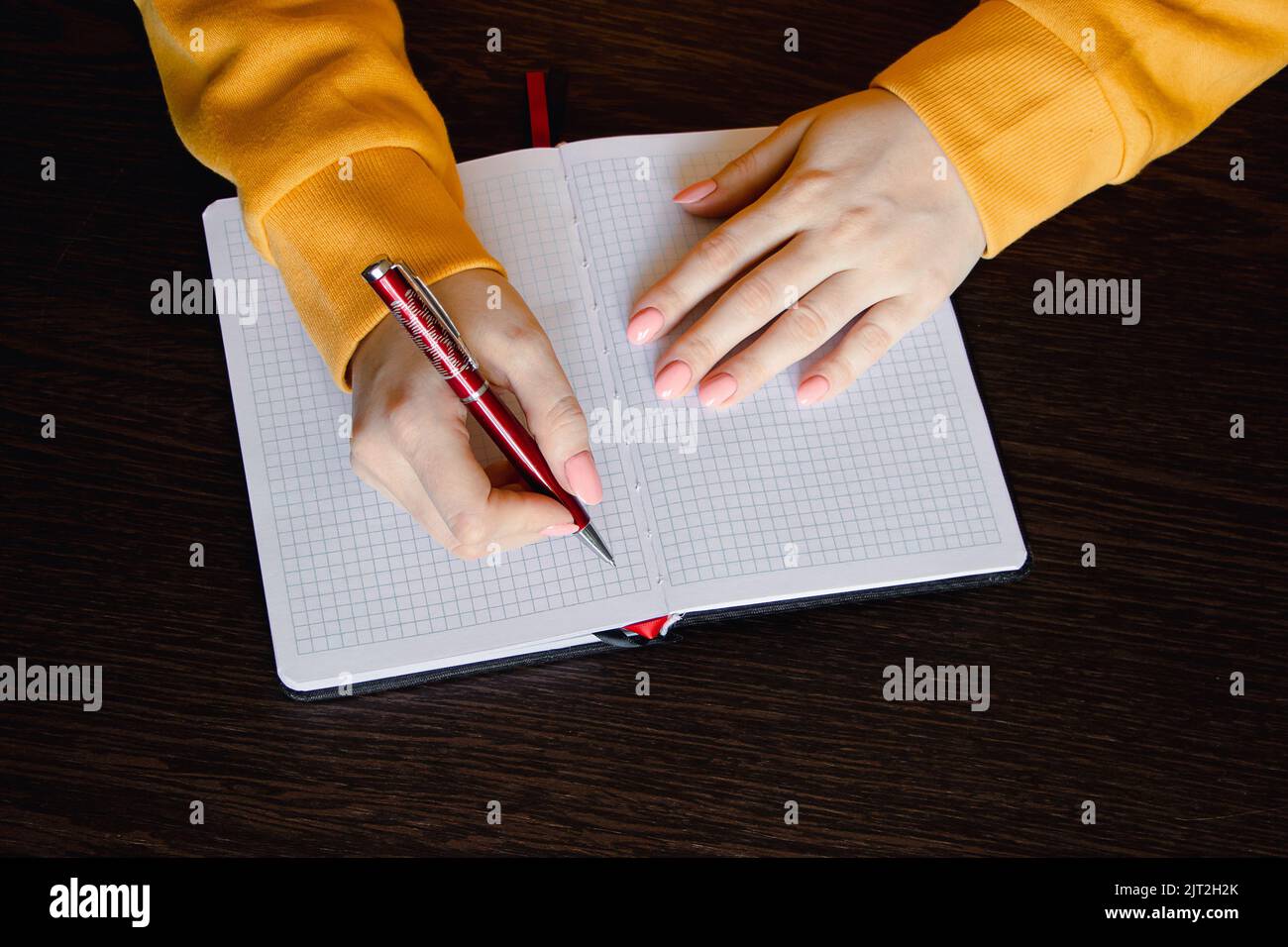 Female student hand up desk hi-res stock photography and images - Alamy