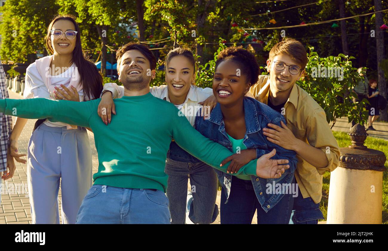 Group of happy funny cheerful diverse friends meet up in summer park ...