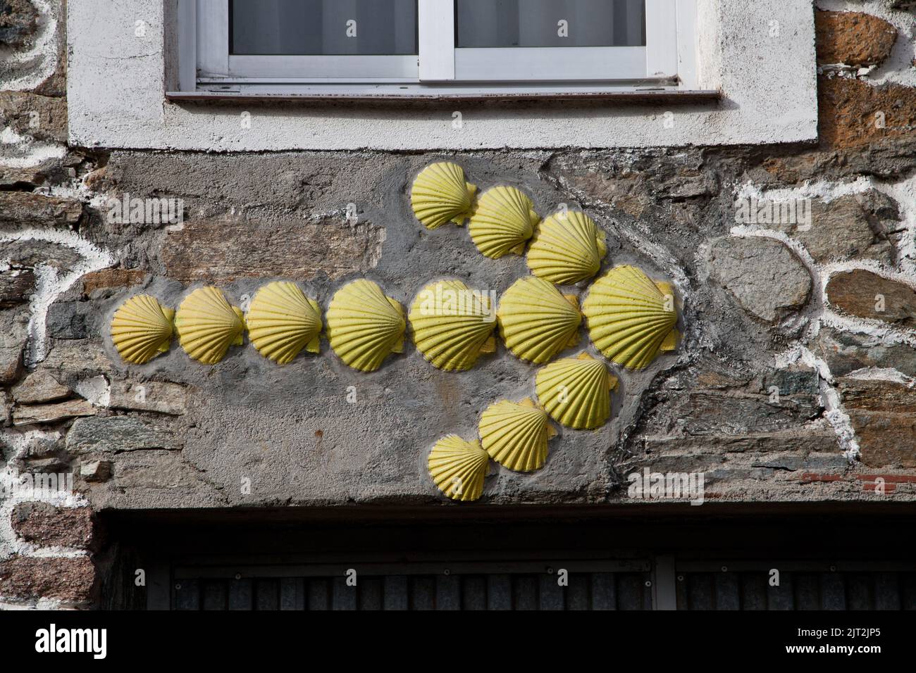 scallop shells shaped to form a yellow arrow, route marker for The Way ...