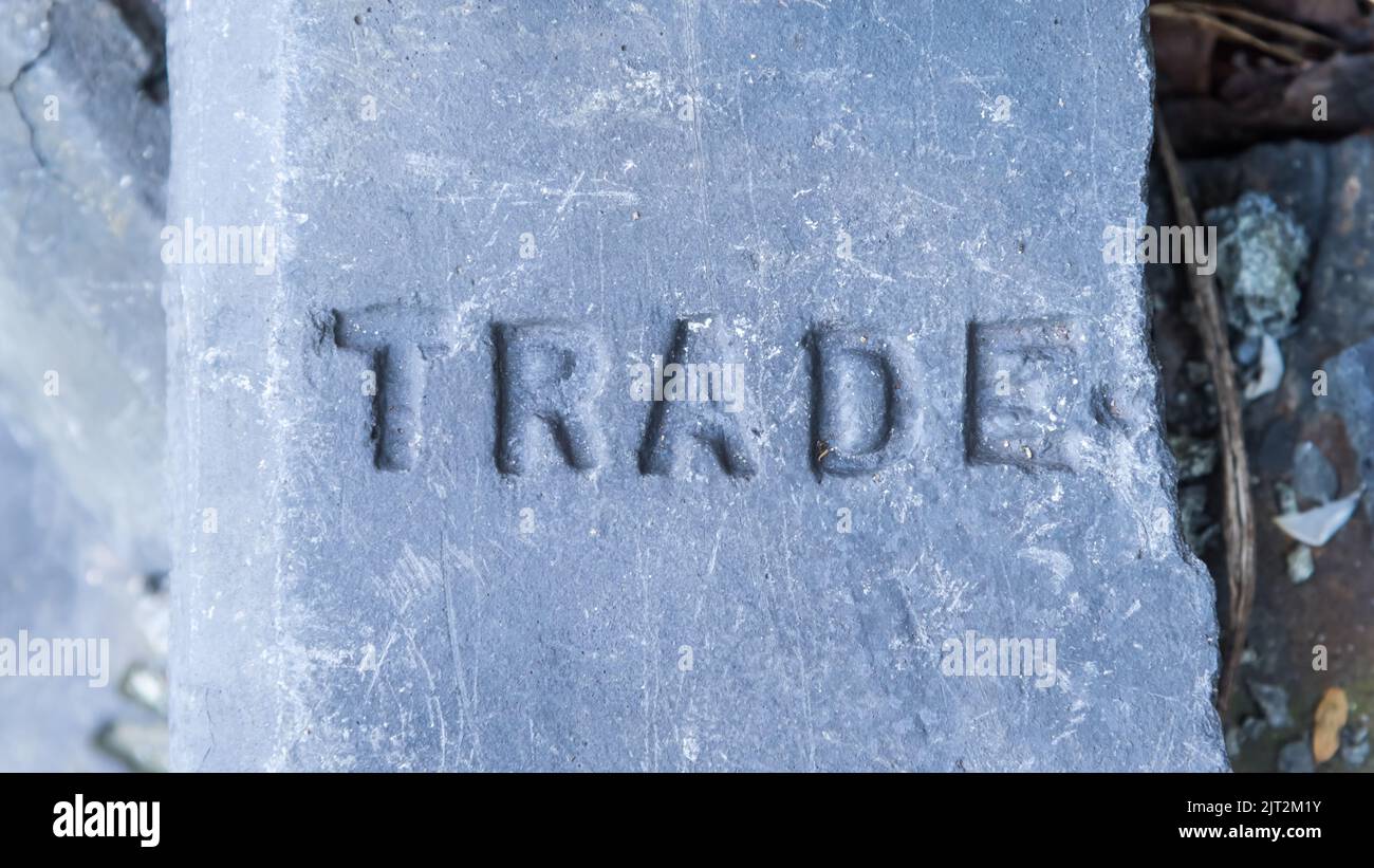 The word TRADE embossed in a blue stone Stock Photo - Alamy