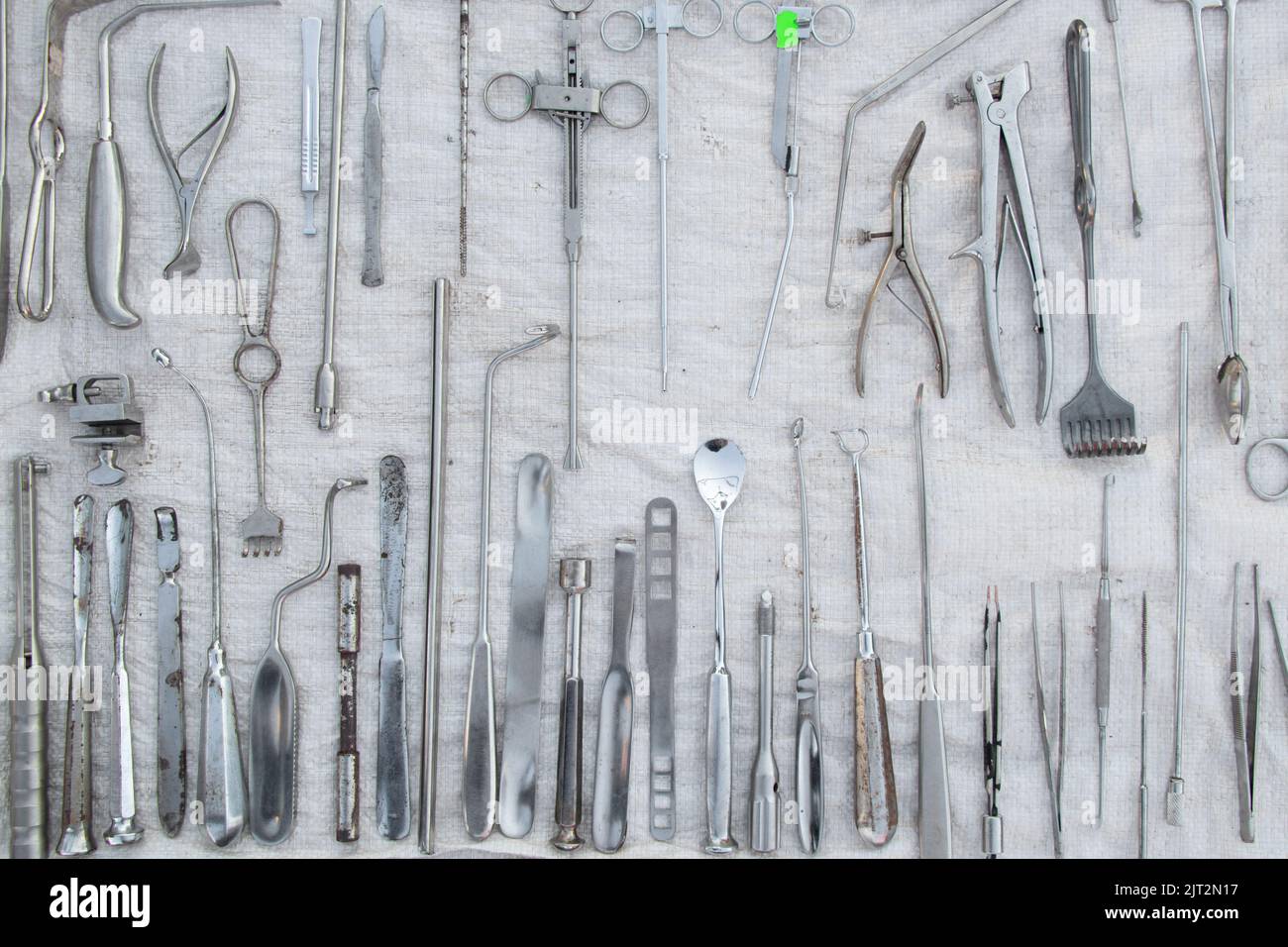 set of old medical instruments clamps ,scalpels and scissors on a white ...