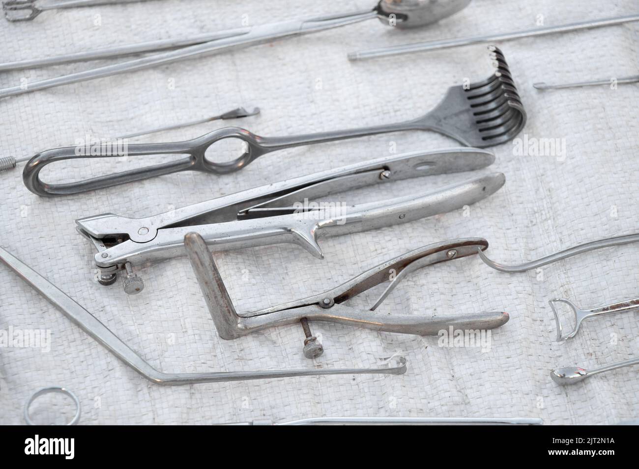 set of old medical instruments clamps ,scalpels and scissors on a white ...