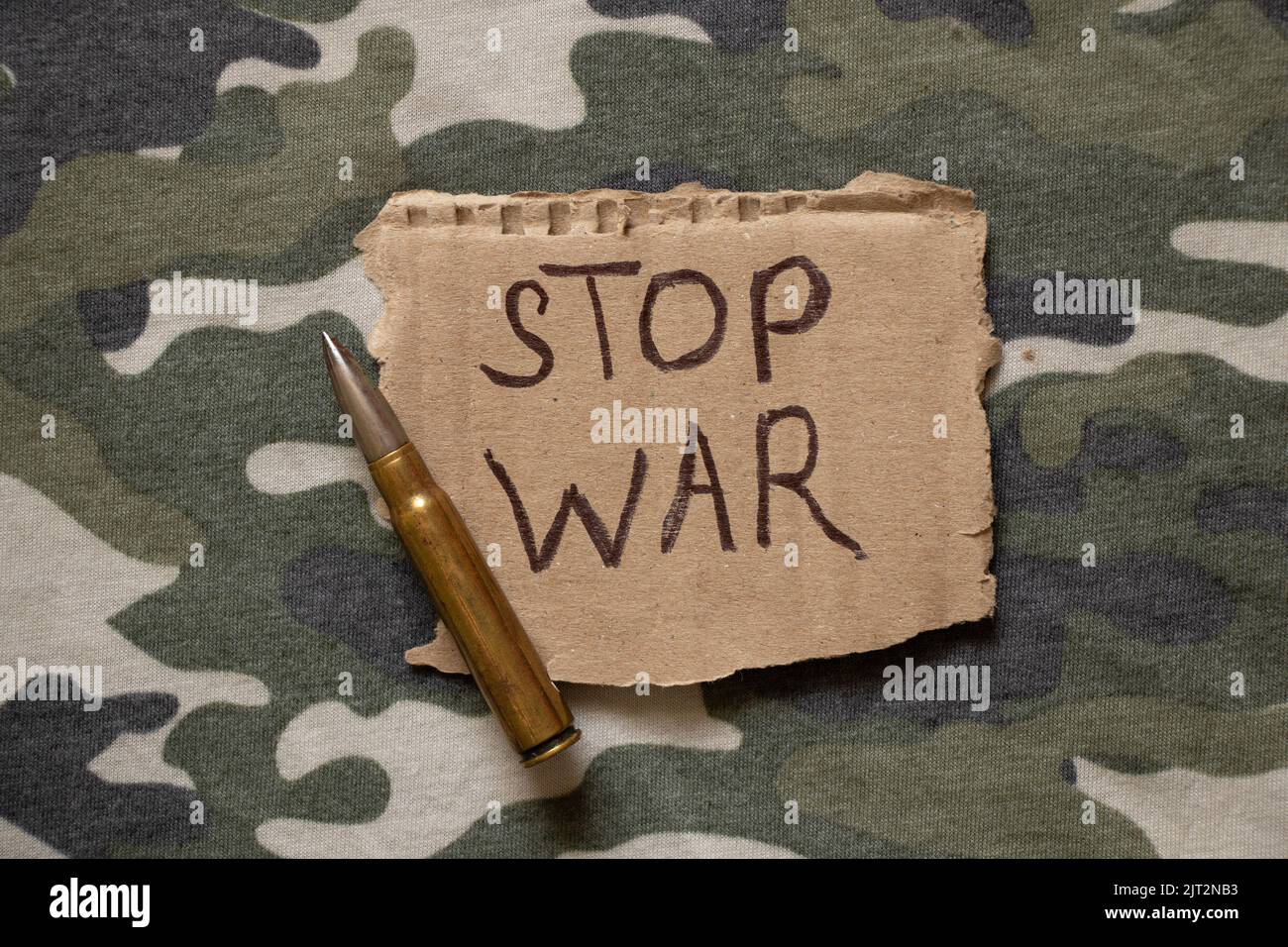 Stop the war is written on paper and a bullet lies nearby, which lies ...