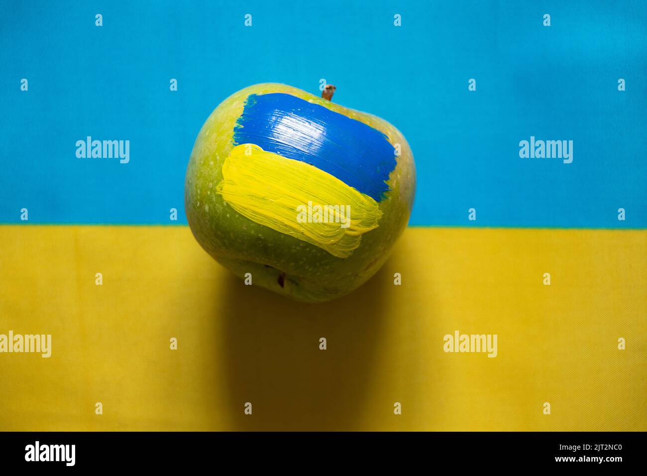 Yellow blue national flag of ukraine and green apple with ukrainian ...