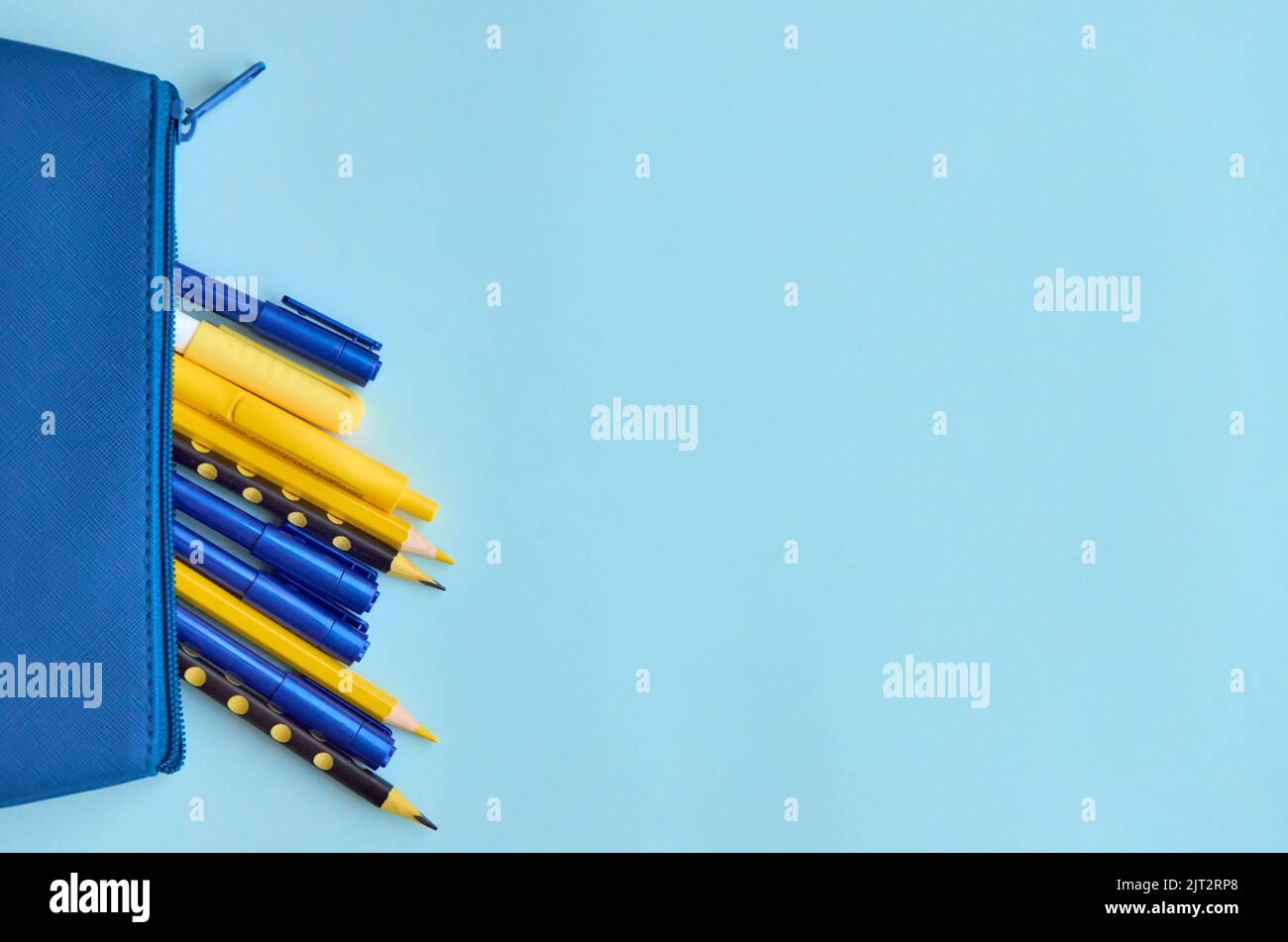 Case with school stationery supplies on grey background, flatlay. Back ...