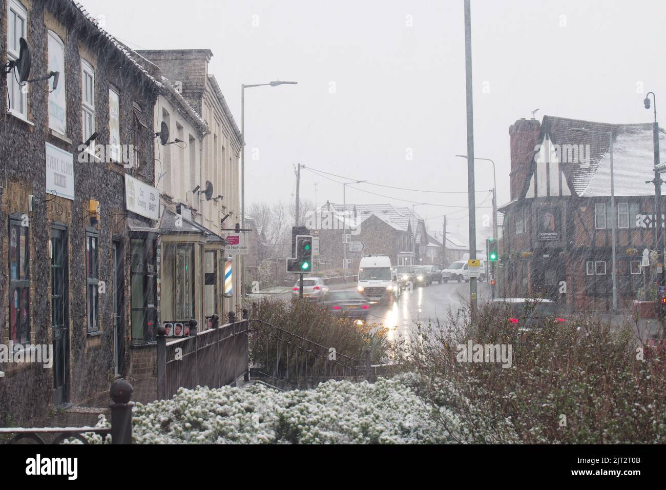 A snowy morning at the end of March on the main road junction in ...