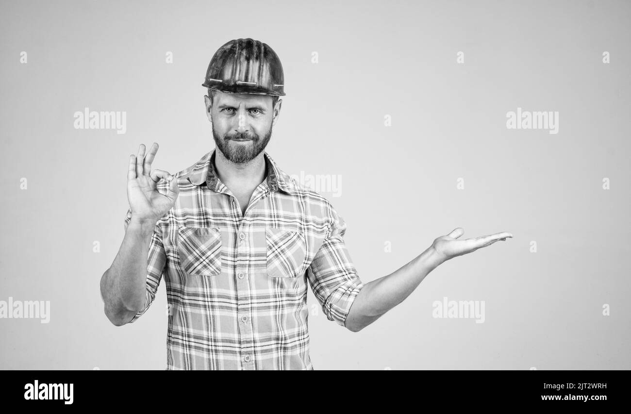 handsome man mechanic in construction safety helmet and checkered shirt ...