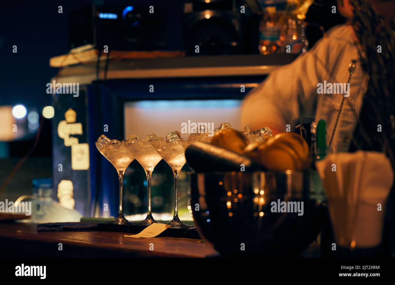A row of fresh, icy cocktails in a bar in Tulum, Mexico at night with ...