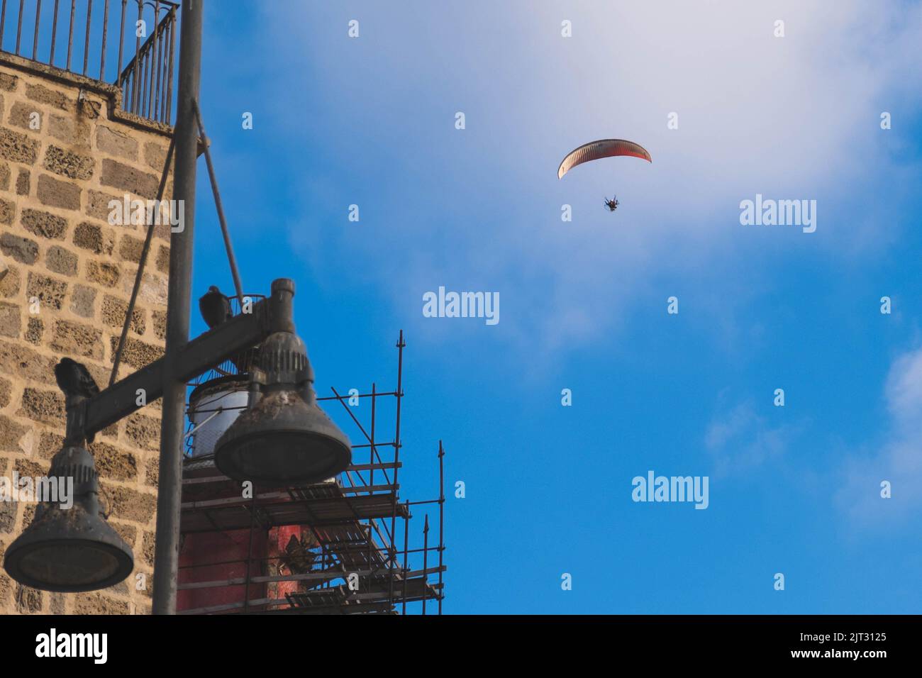 motorized parachute flies with blue sky and a cloud behind Stock Photo ...