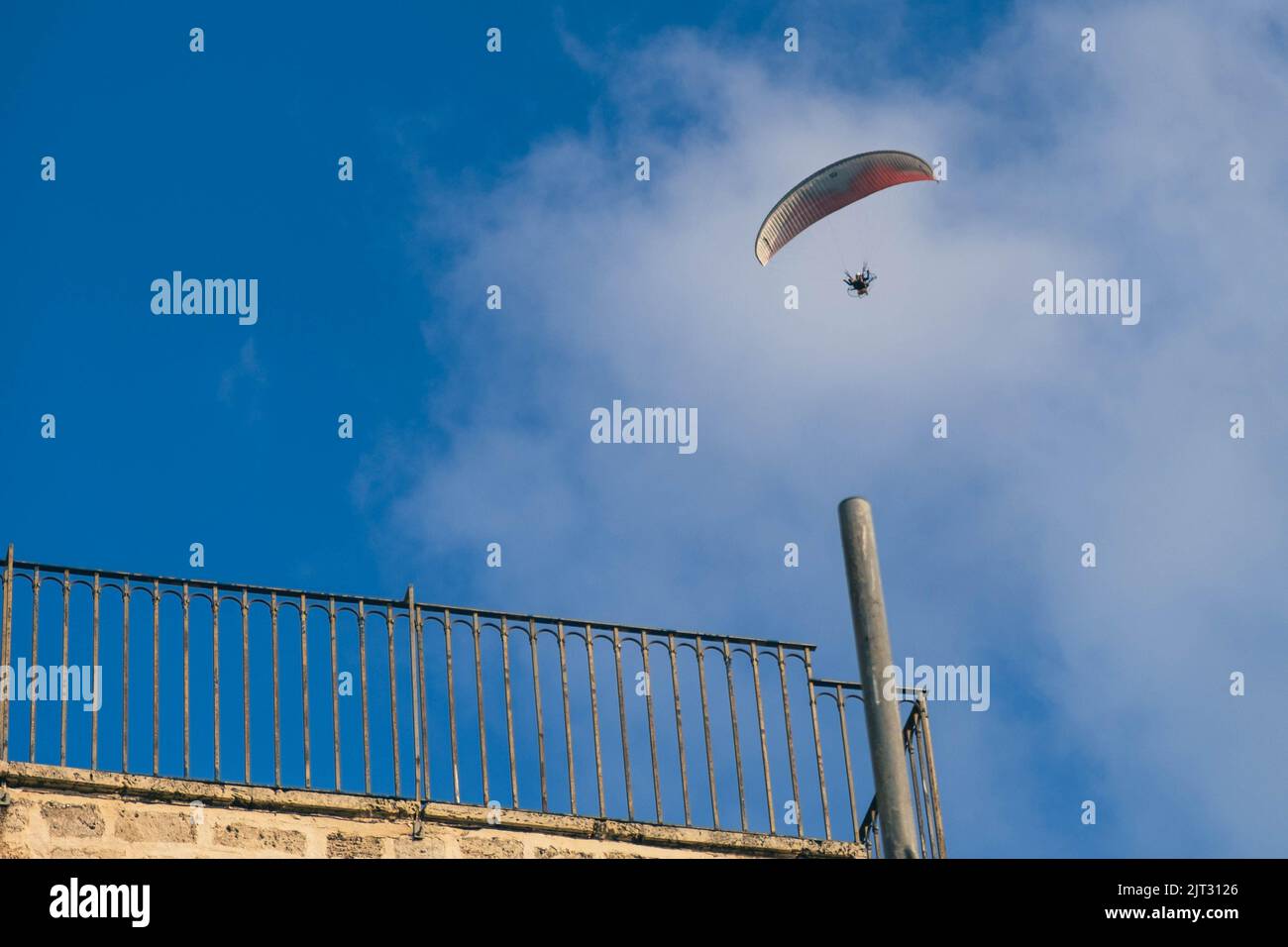 motorized parachute flies with blue sky and a cloud behind Stock Photo ...