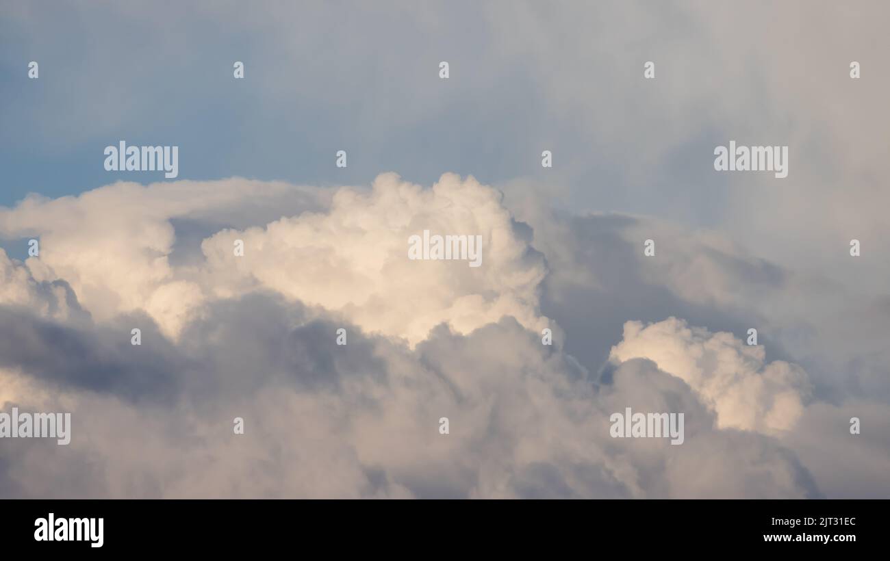 Puff Clouds in the Sky during sunset Stock Photo - Alamy