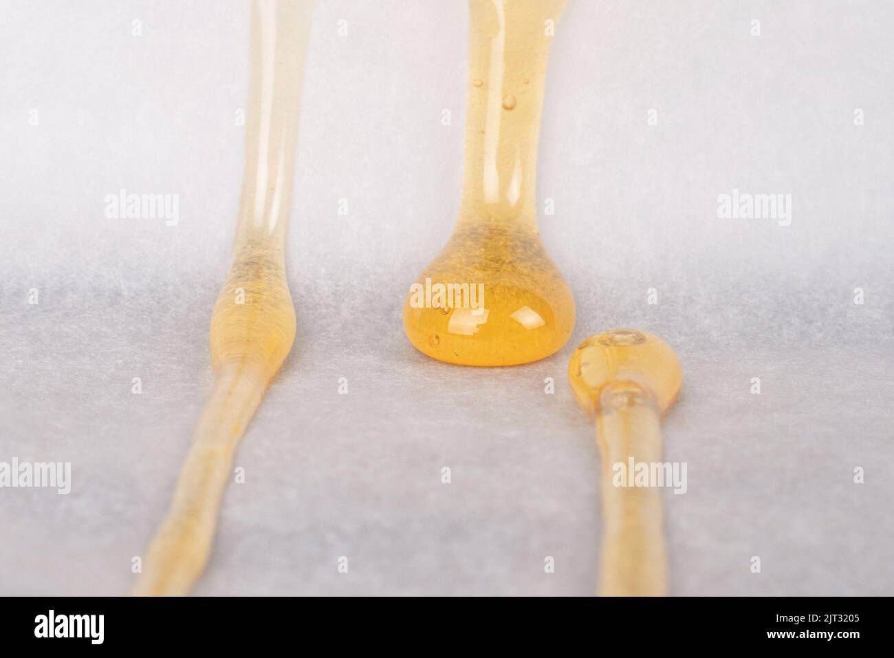 dripping drops of yellow cannabis wax with a high content of thc on ...