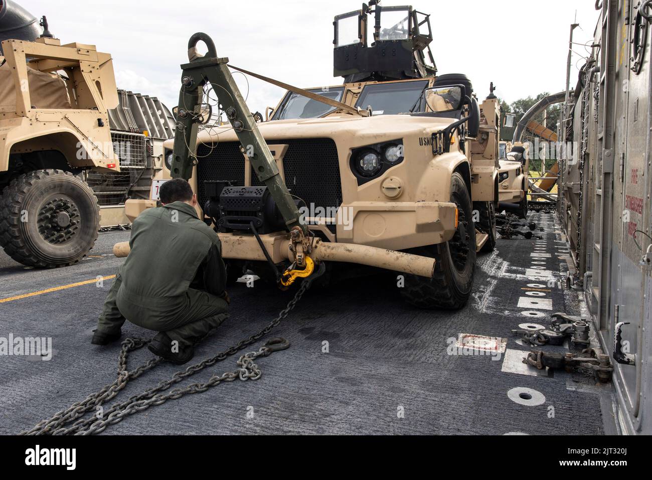 A U.S. Navy Sailor assigned to USS New Orleans (LPD 18), tightens a ...