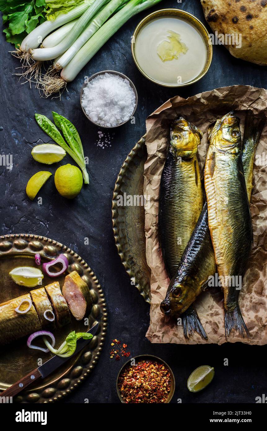 Mediterranean food, smoked Herring fish served with green onion, lemon ...