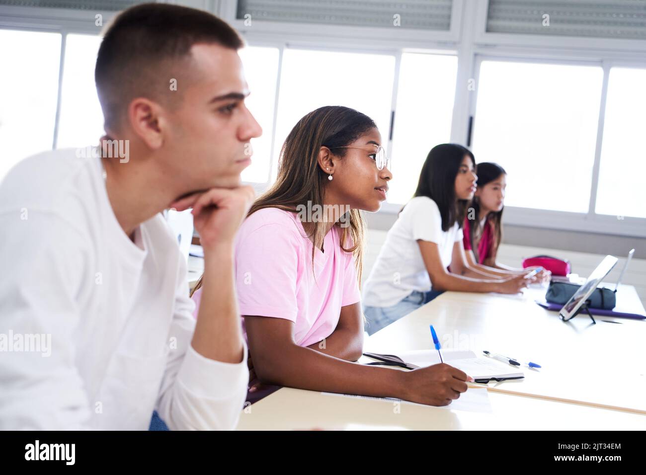 University student listening lecture while attending a class in the ...