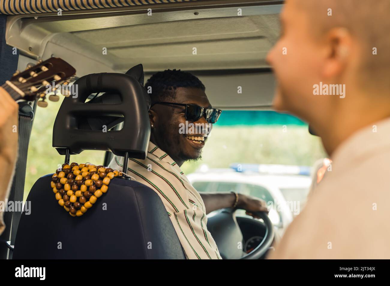 Multi-ethnic group of close friends having a summer road trip in a ...