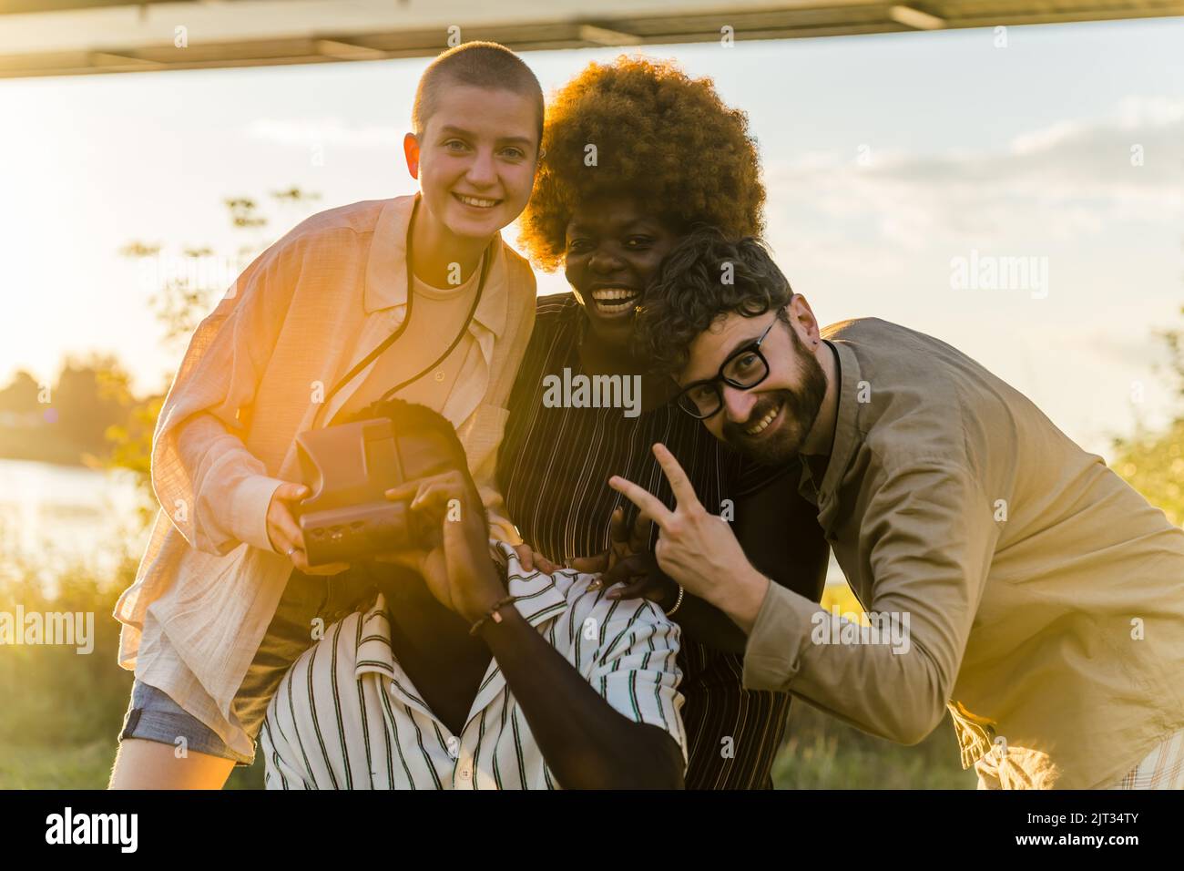 Multi-ethnic group of smiling good old friends, who finally reunited ...