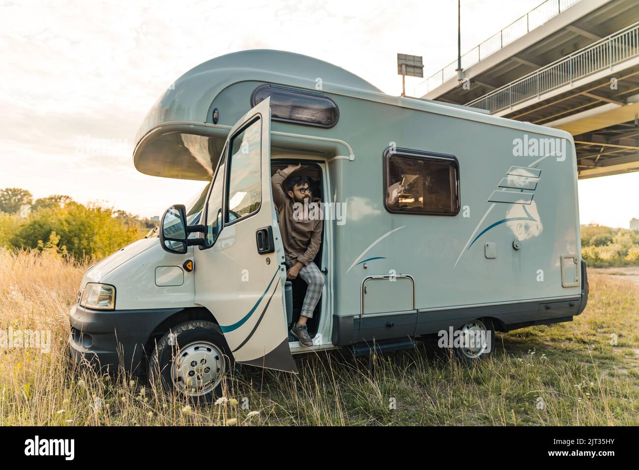 Stylish rich young bearded man sitting on the driver seat of his own ...
