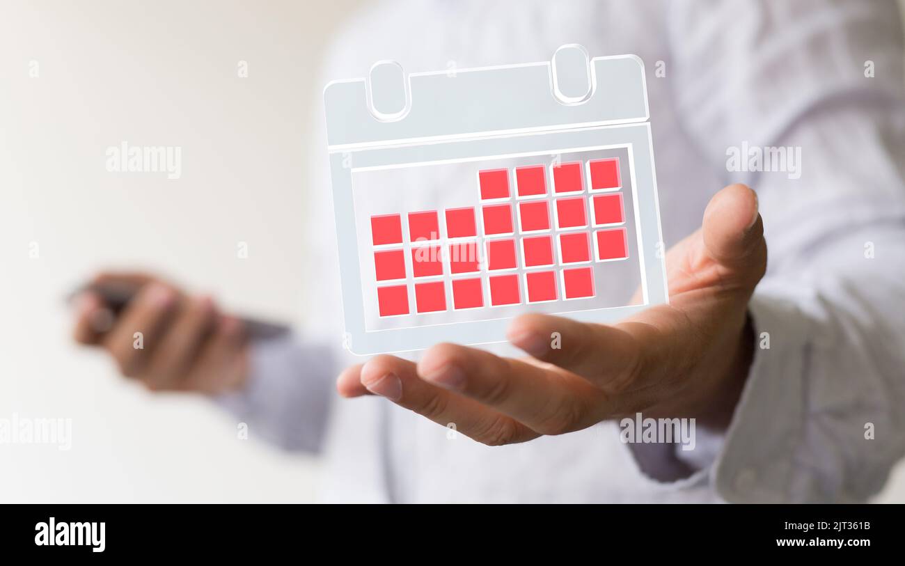 A human hand touching a calendar icon with a blurred background Stock ...
