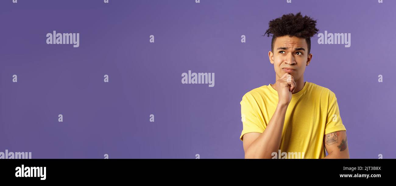 Close-up portrait of indecisive, puzzled attractive young man have ...