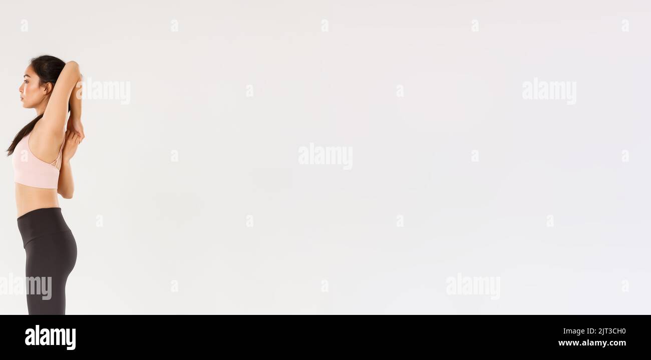 Full length profile of focused strong asian female coach, sportswoman ...