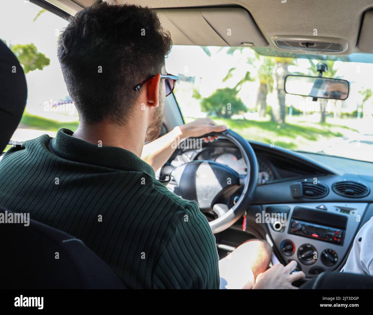A back view of a young male driver in his car Stock Photo - Alamy
