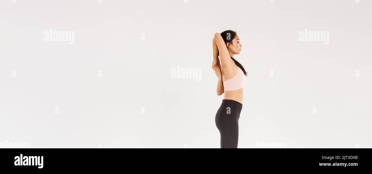 Full length profile of focused strong asian female coach, sportswoman ...