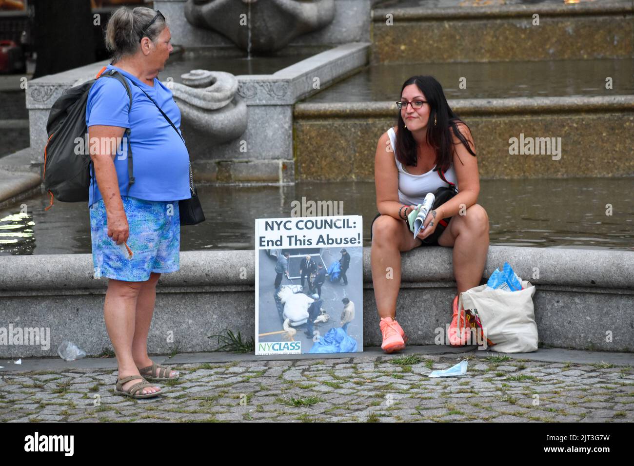 Rally participant is holding an animal anti-abuse sign in front of the ... Rally participant is holding an animal anti-abuse sign in front of the ...