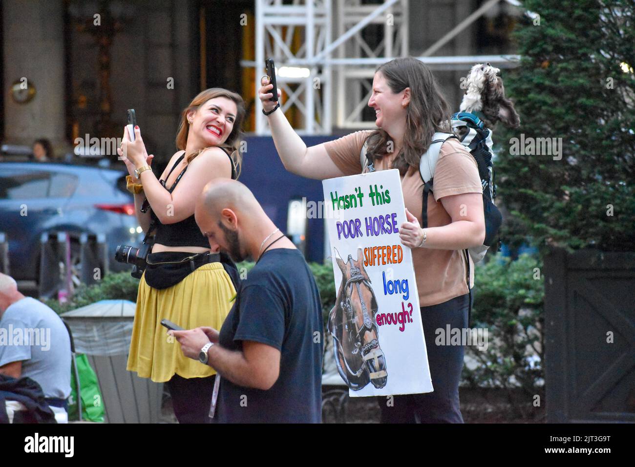 Rally participants holding animal anti-abuse signs in front of the ... Rally participants holding animal anti-abuse signs in front of the ...