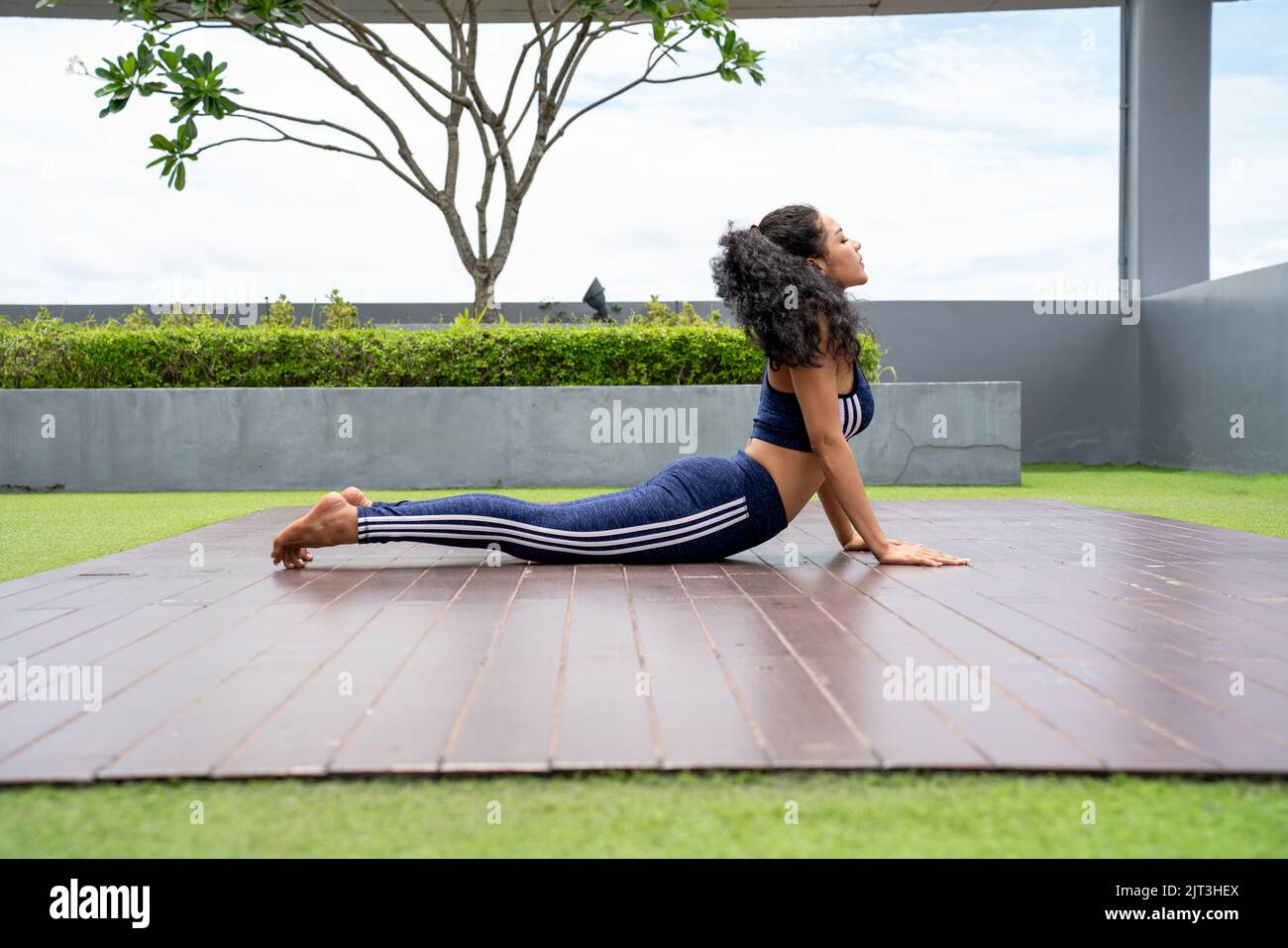 yoga meditates against modern skyscrapers. Young girl spending time ...