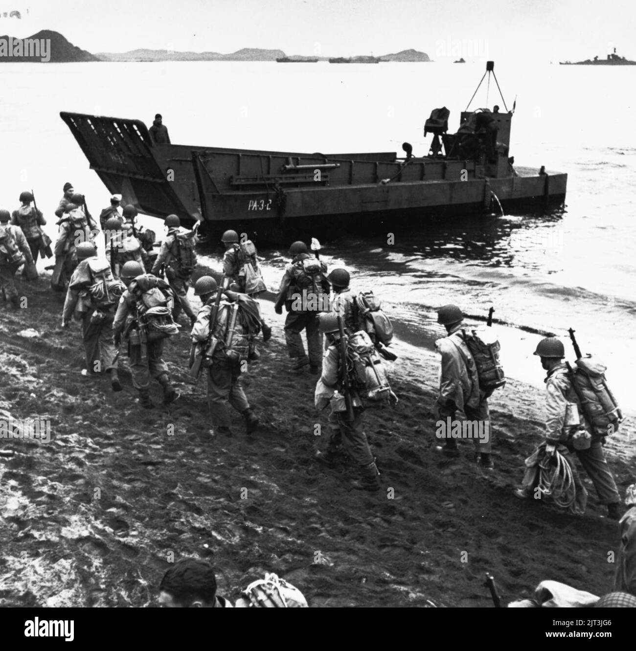 Troops marching up beach during loading for Kiska operation, 13 August ...