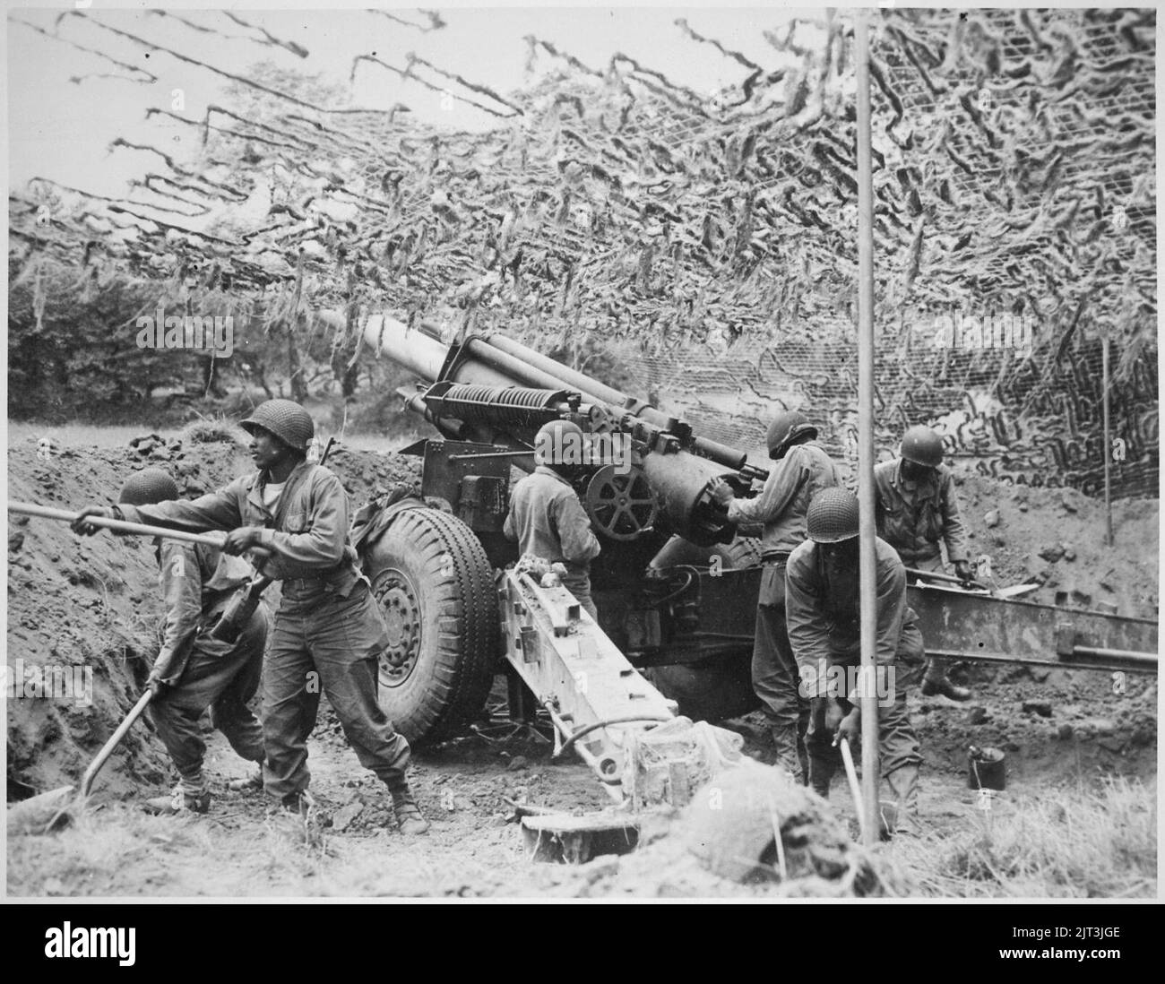 Troops of a field artillery battery emplace a 155mm howitzer in France ...
