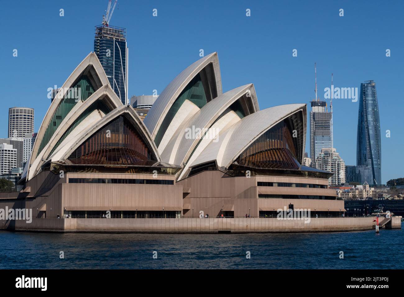 The Sydney Opera House as seen from the water on a beautiful blue sky ...