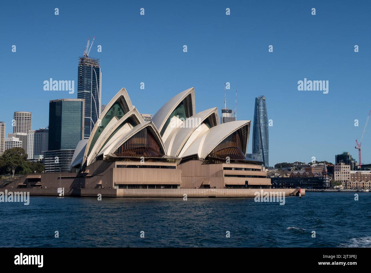 The Sydney Opera House as seen from the water on a beautiful blue sky ...