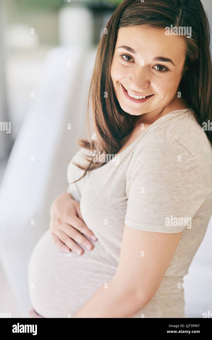 I cant wait to meet the little one. a young woman posing with her ...