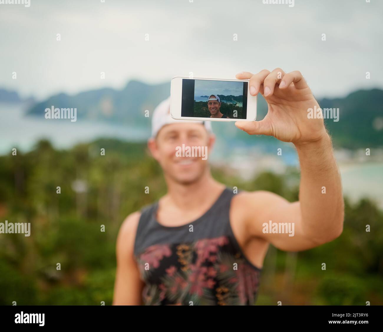 This is a selfie-worthy view. a happy young man taking a selfie with ...