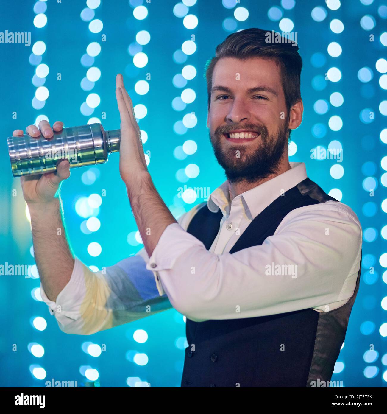 They call me the mix master. Portrait of a handsome young bartender ...