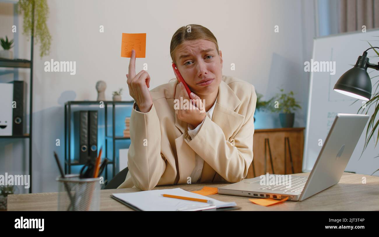 Tired exhausted businesswoman in suit working on laptop at office with ...