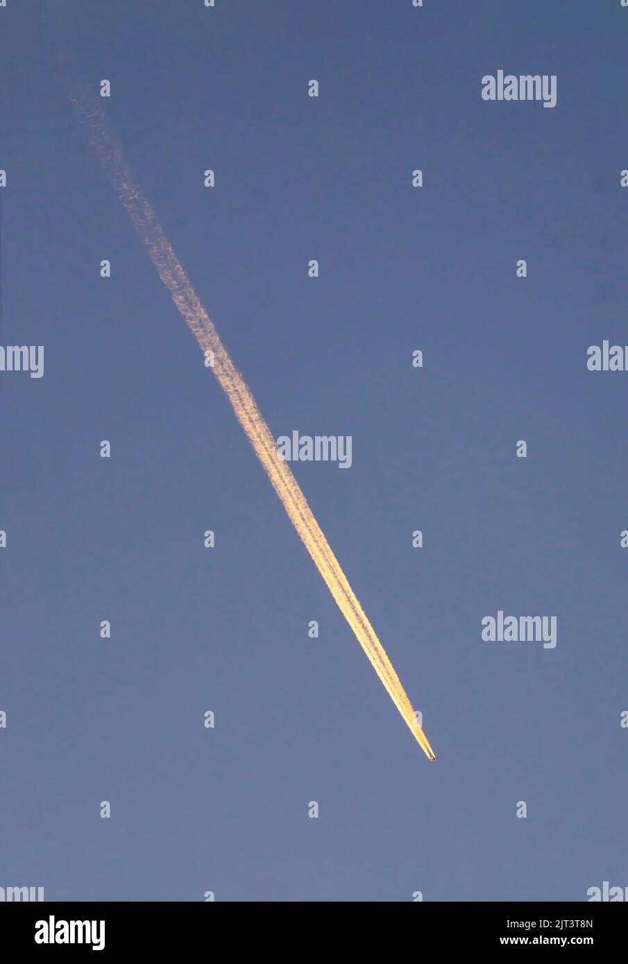 A jet leaving contrail in early morning sky Stock Photo - Alamy