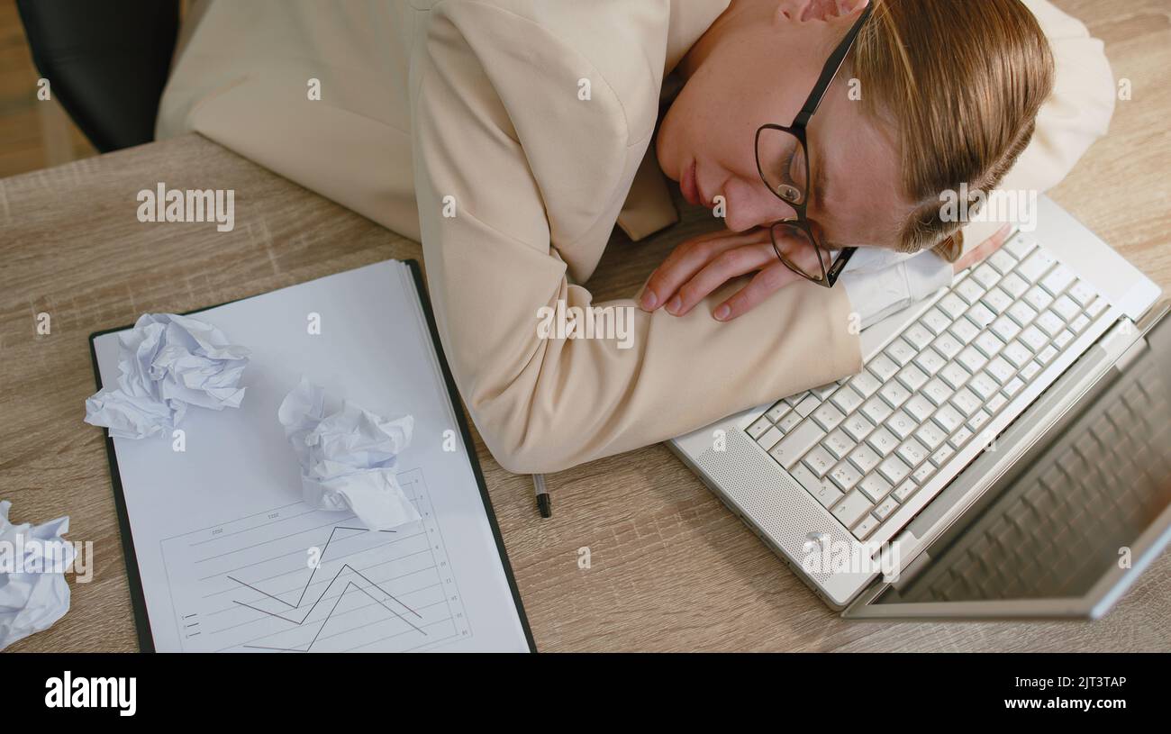 Bored sleepy businesswoman programmer software developer in formal wear suit falling asleep ...