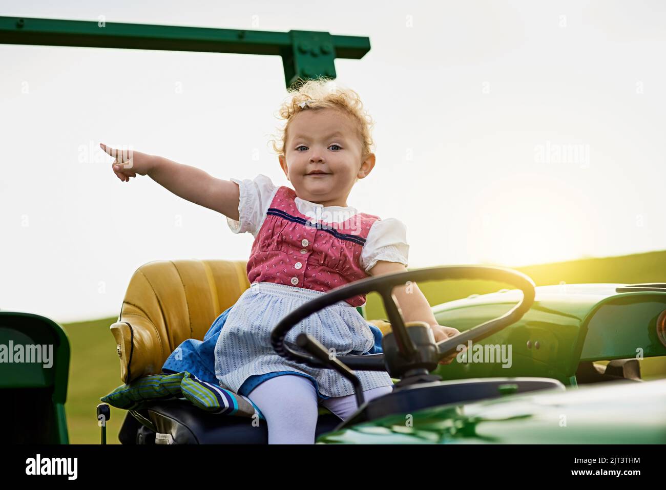 Those fields need plowing. Portrait of an adorable little girl riding a ...