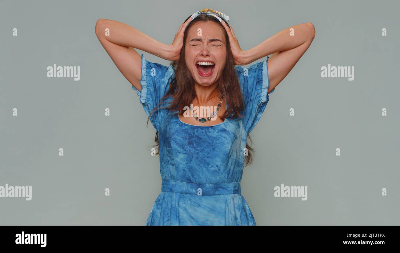 Angry sad young woman screams from stress tension problems feels horror ...