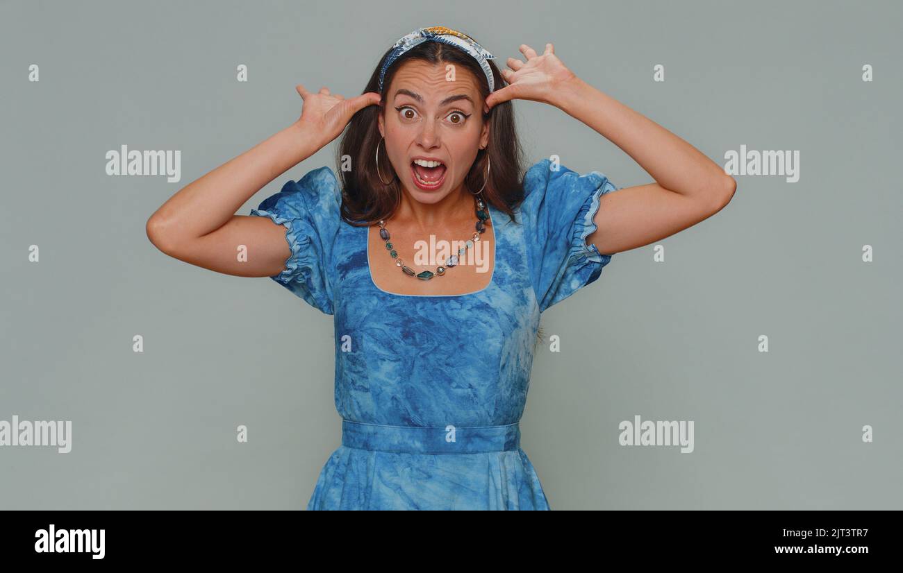 Lovely pretty funny woman in dress making playful silly facial ...